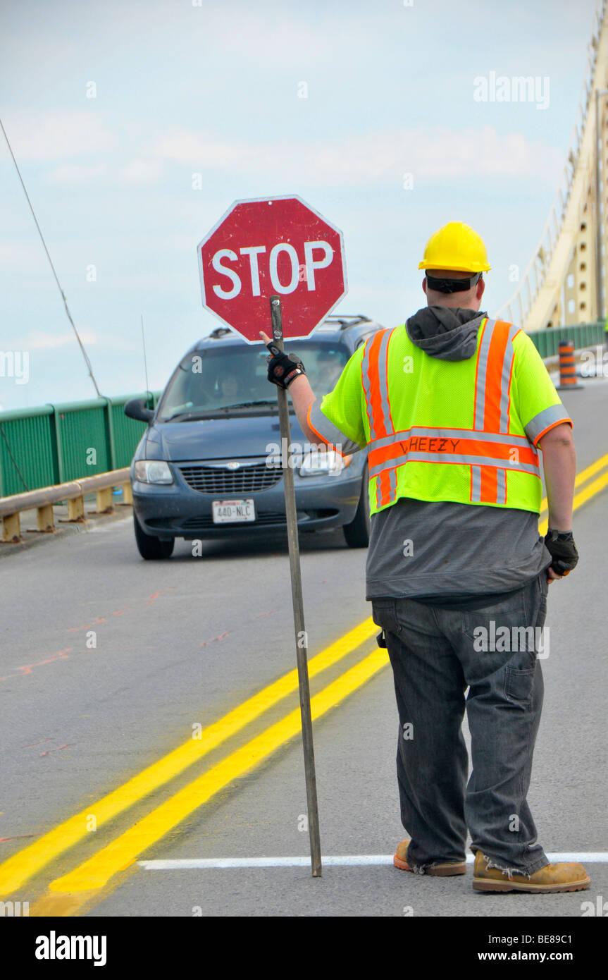 Construction Worker Controls traffic on International Bridge Stock ...