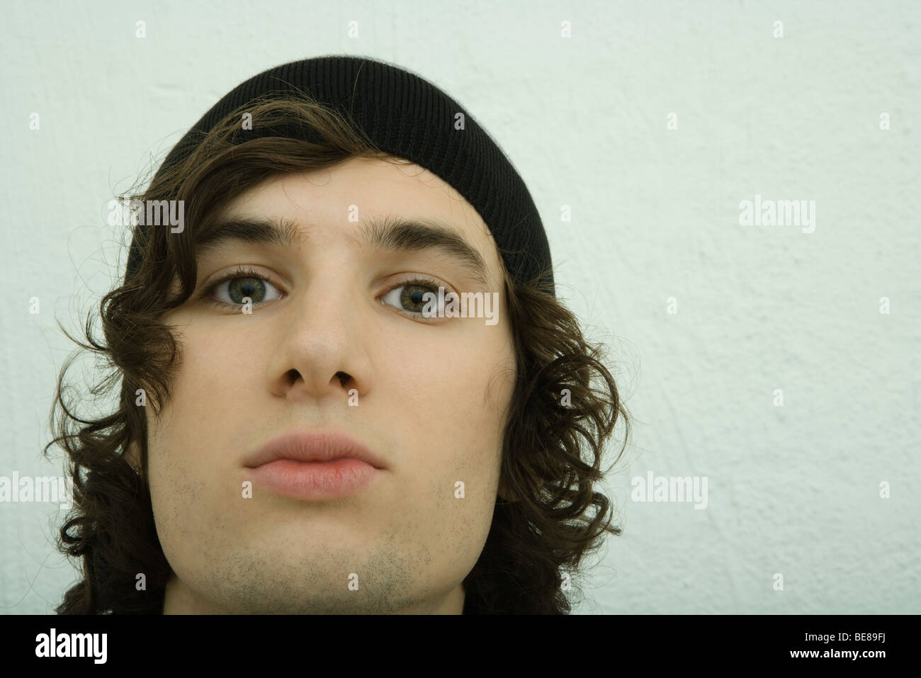 Young man staring at camera, close-up Stock Photo - Alamy