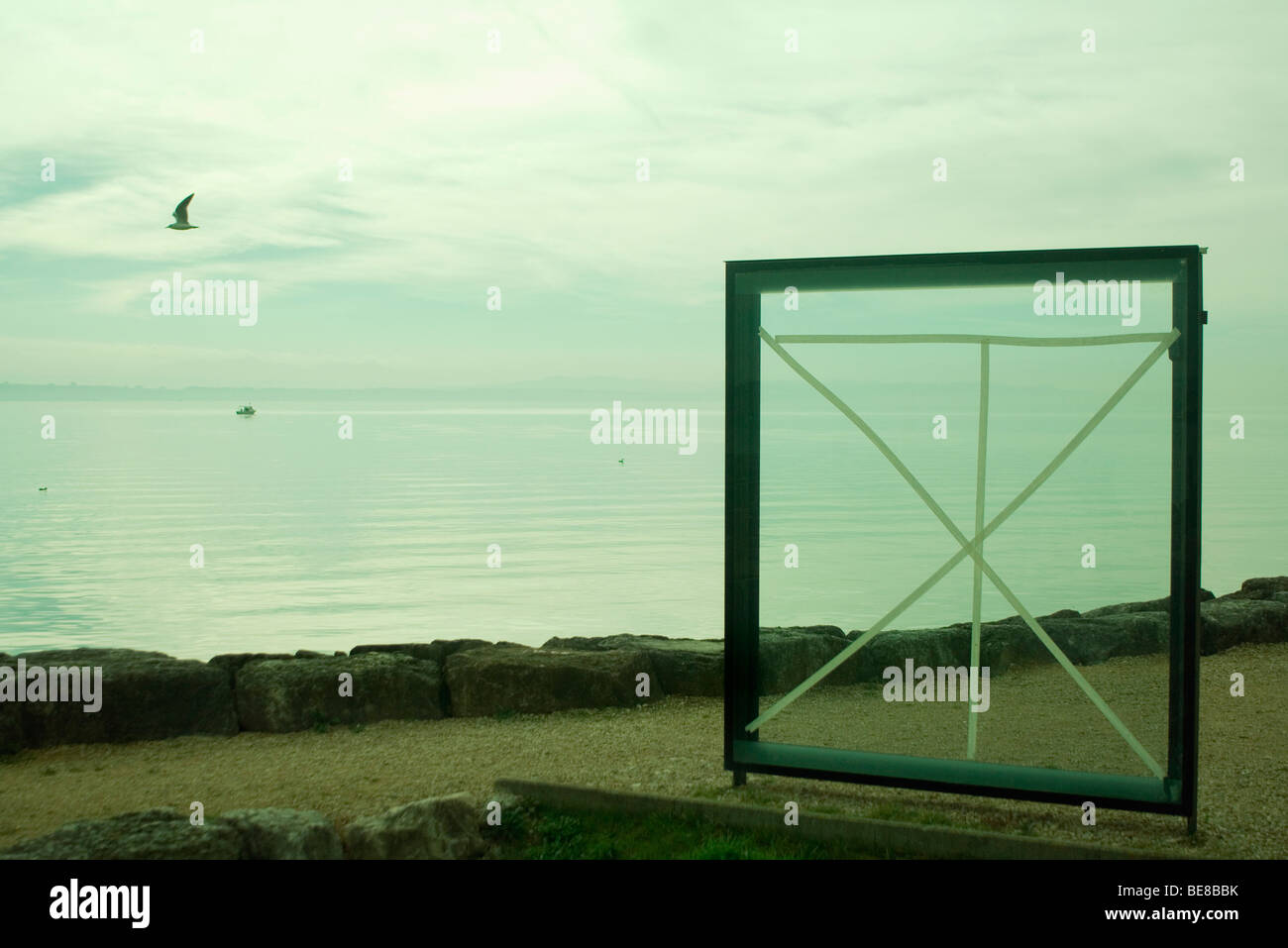 Window with glass taped at seaside, gull flying in background Stock ...