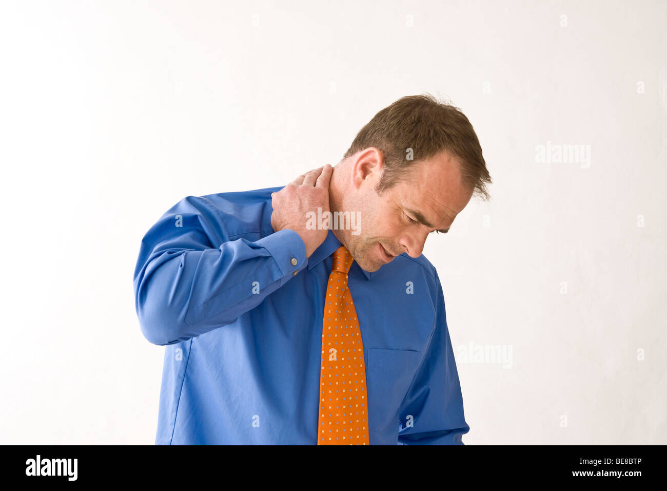 Man wearing tie and shirt, hand on his aching neck Stock Photo - Alamy