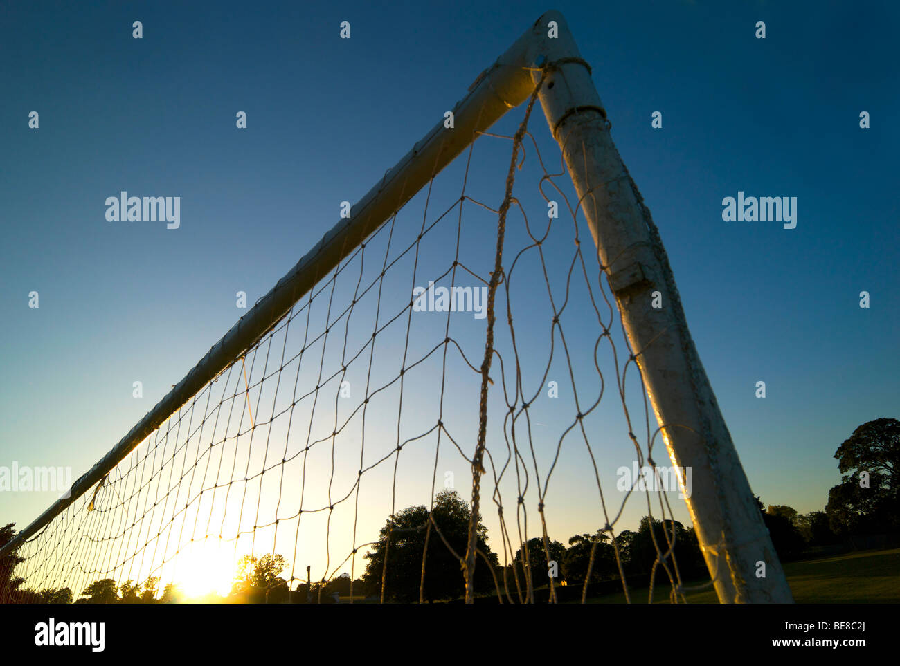 Sunset through some football nets Stock Photo - Alamy