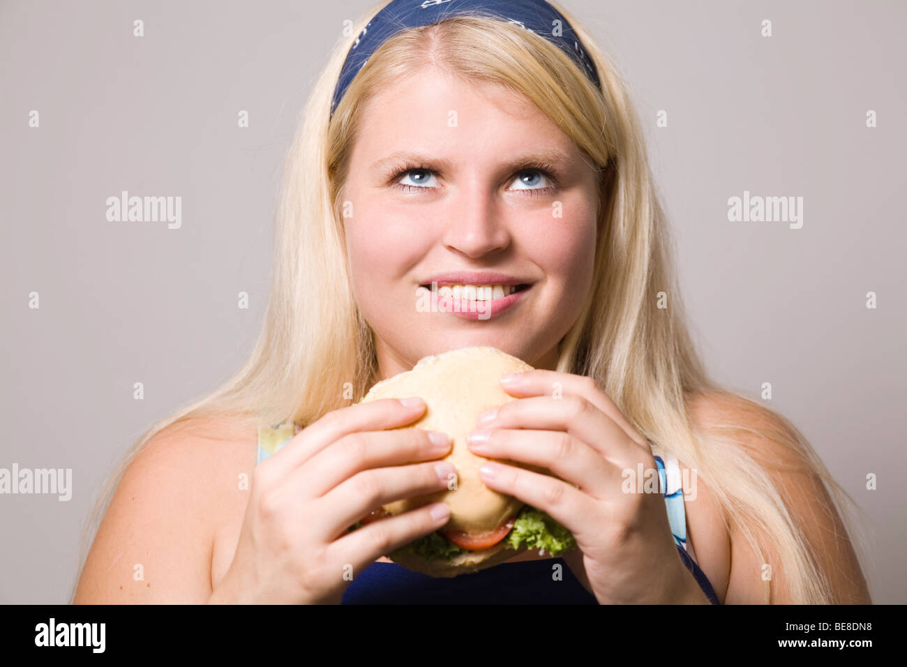Young fat woman is eating fast food hamburger Stock Photo - Alamy