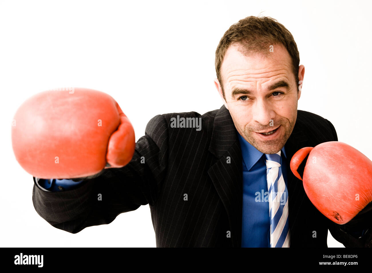 Portrait of a man wearing a suit, with boxing gloves Stock Photo - Alamy