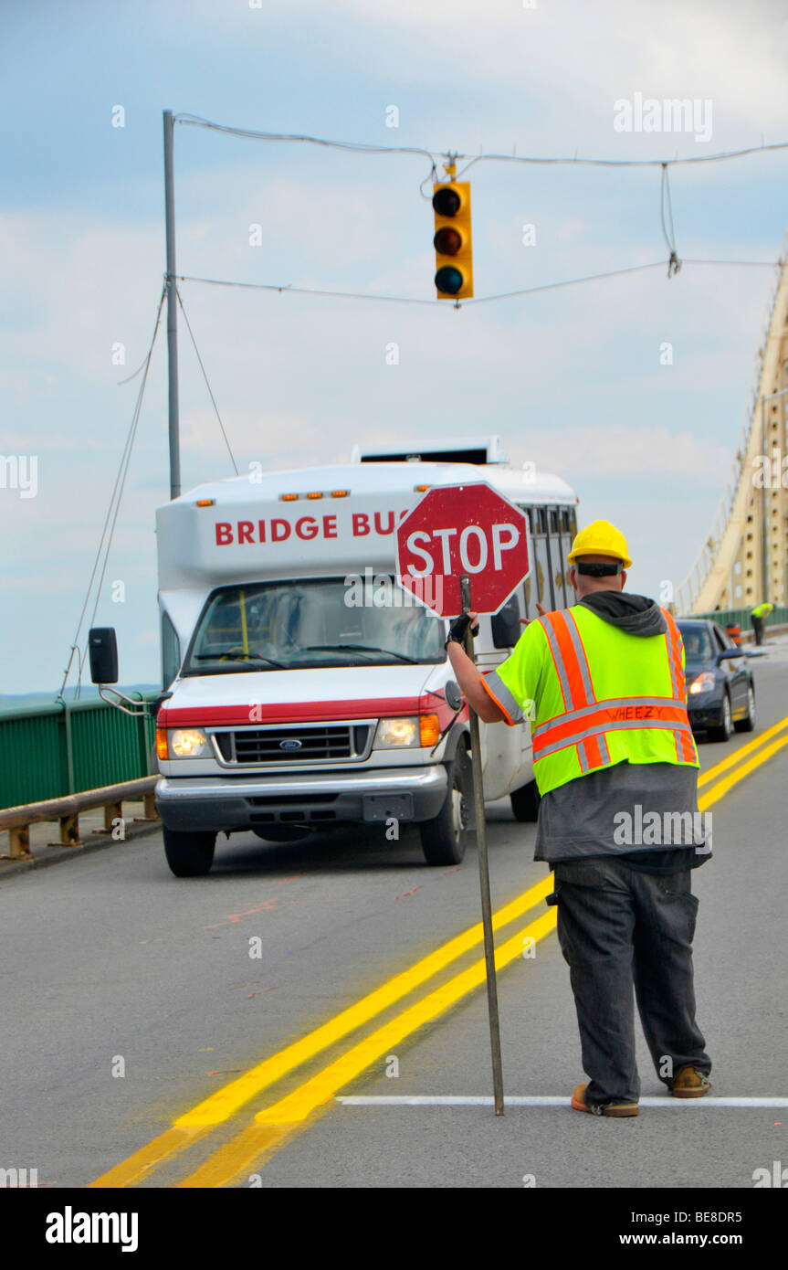 Construction Worker Controls traffic on International Bridge Stock ...