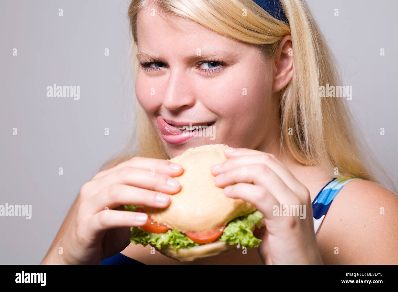 Young fat woman is eating fast food hamburger Stock Photo - Alamy