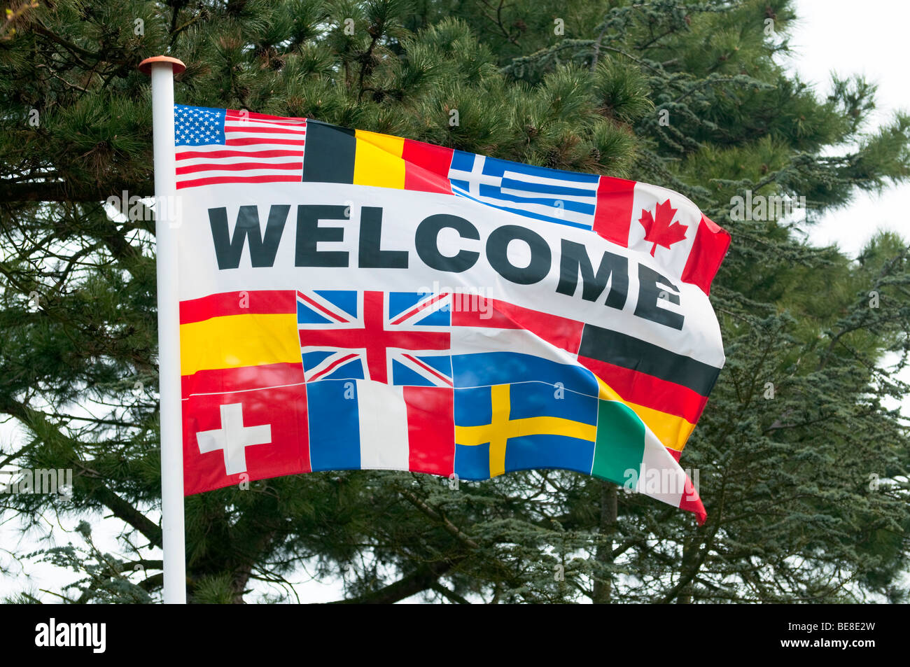 A banner with various flags blows in front of a vacation resort at the ...