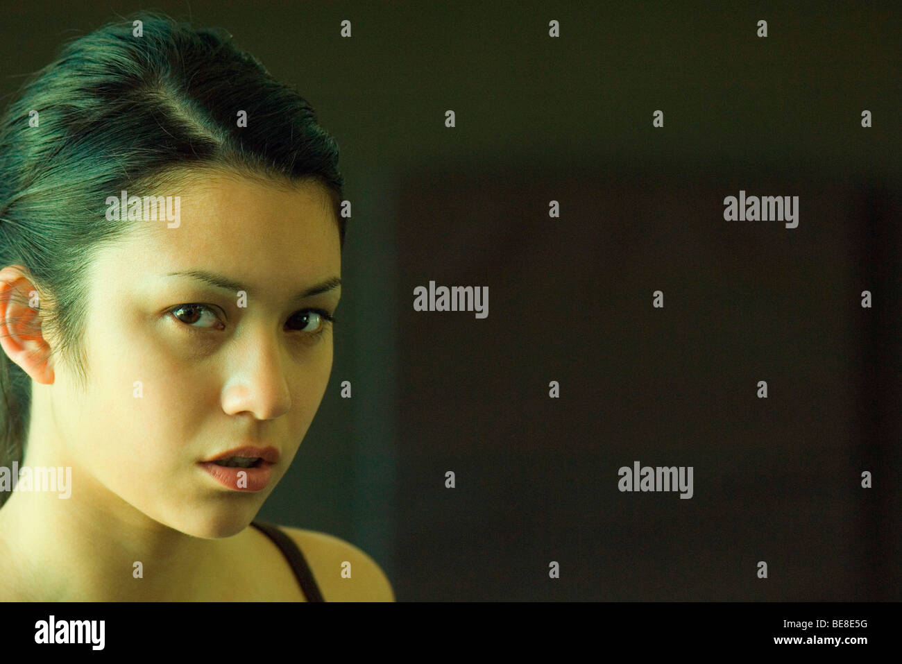 Young woman scowling at camera, portrait Stock Photo - Alamy