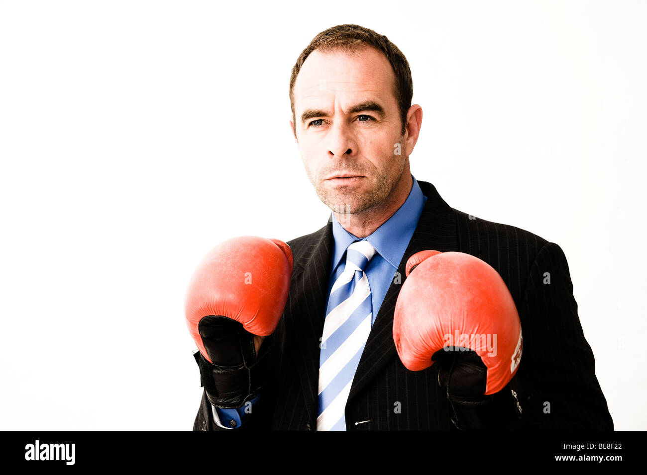 Portrait of a man wearing a suit, with boxing gloves Stock Photo - Alamy