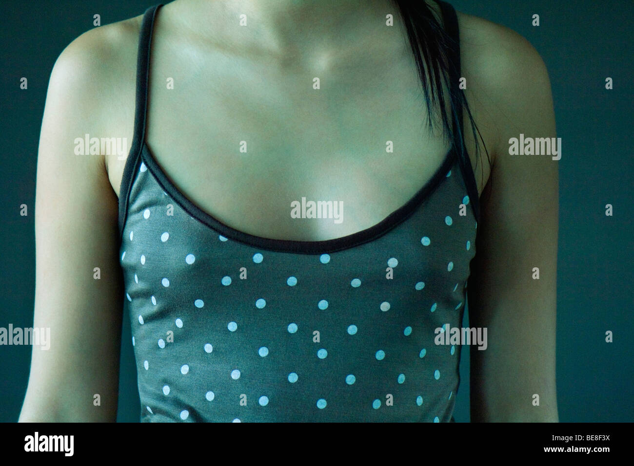 Teenage girl wearing polka dot tank top, cropped Stock Photo: 26003038 ...