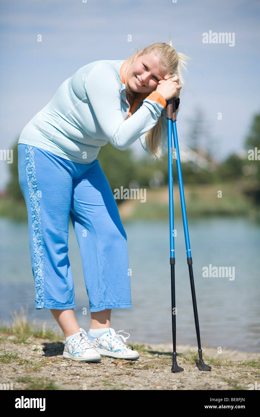 Young fat woman posing with nordic walking sticks Stock Photo - Alamy