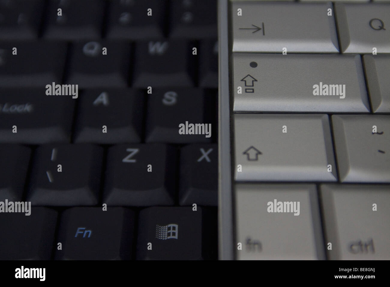 silver Apple Mac keyboard alongside PC keyboard Stock Photo - Alamy