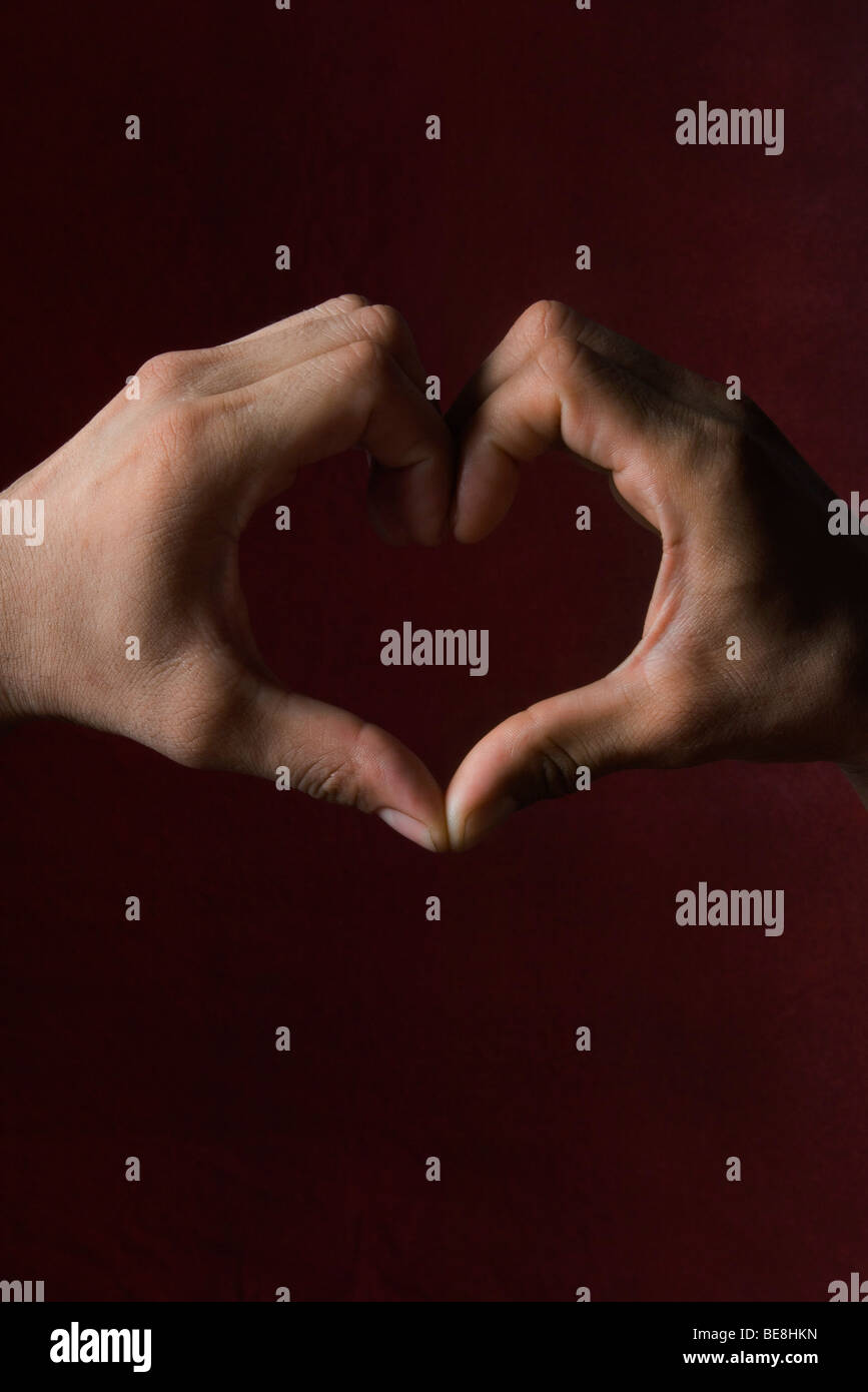 Hands together forming heart Stock Photo - Alamy