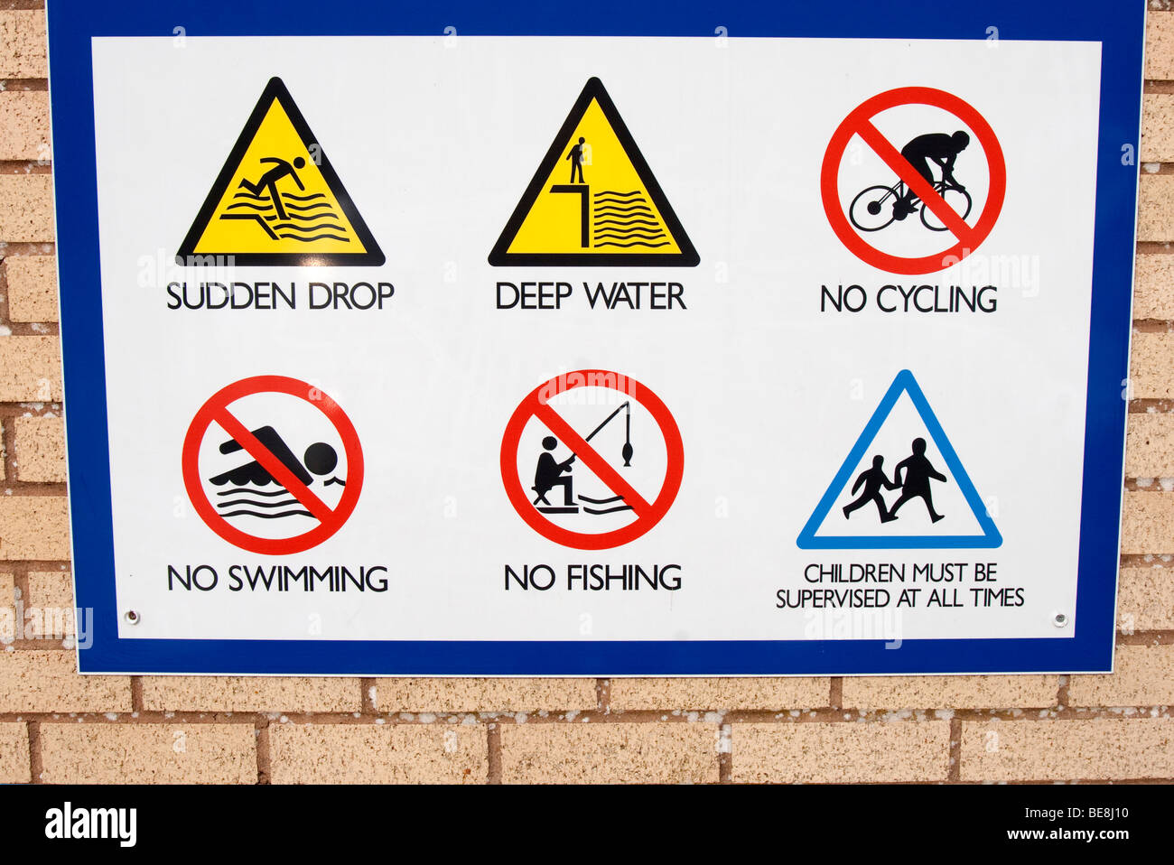 warning sign on wall in a marina Stock Photo - Alamy