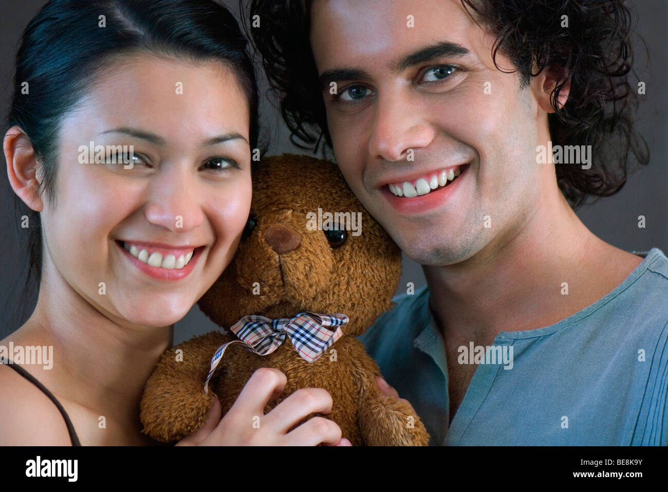 Young couple with teddy bear, portrait Stock Photo - Alamy