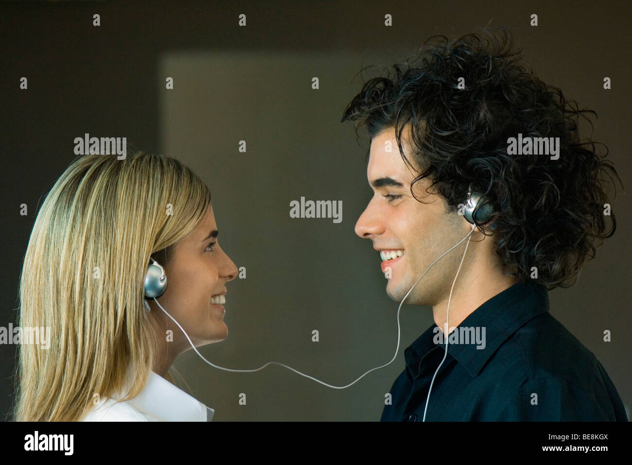 Couple sharing earbuds hi-res stock photography and images - Alamy