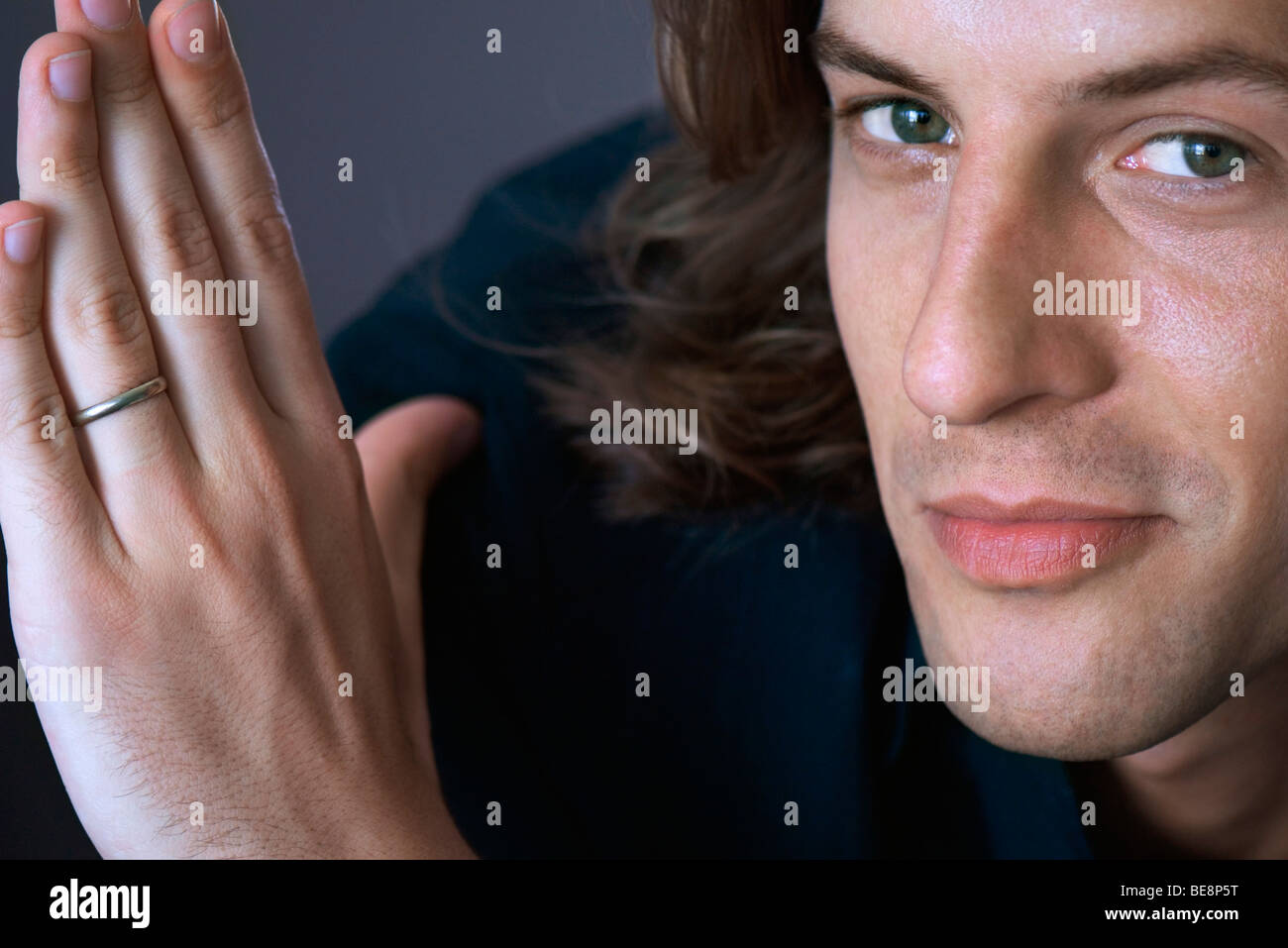 Man holding up hand showing wedding ring Stock Photo - Alamy