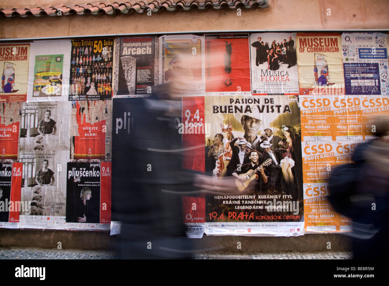 Man walking past posters hi-res stock photography and images - Alamy