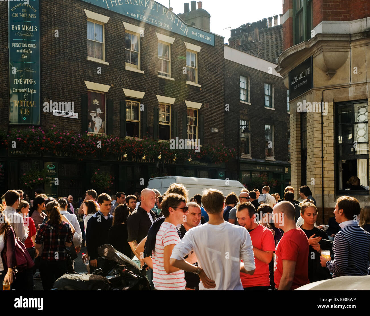 A crowd of people standing outside a pub in Borough Market in London ...