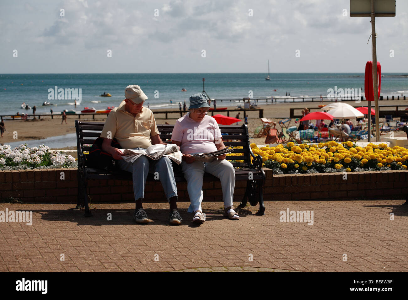 two elderly people relaxing at the beach on the Isle of Wight Stock ...