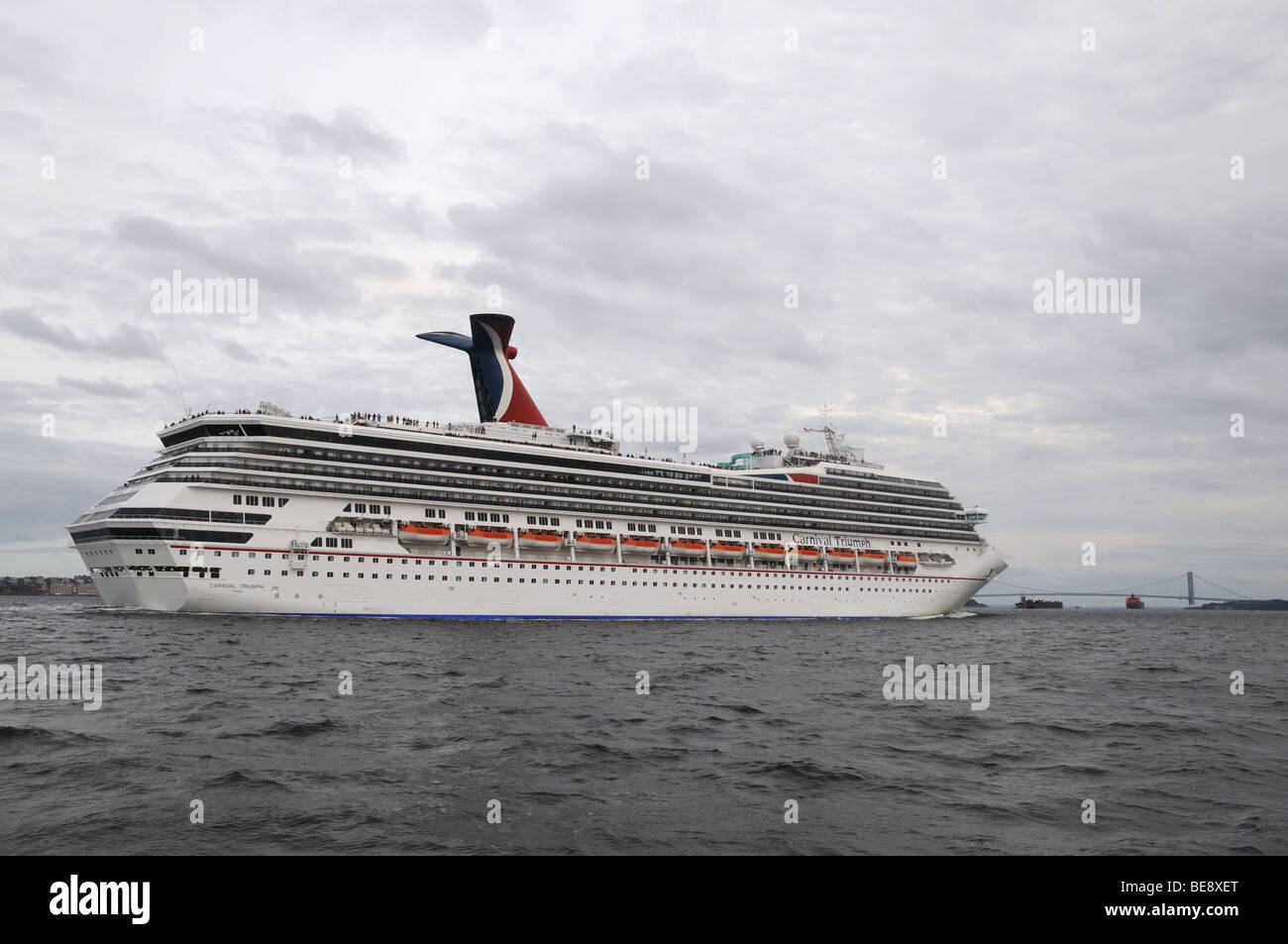 Passengers line the decks of Carnival Triumph as she leaves New York ...