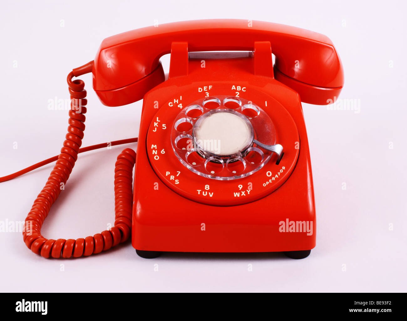 An orange rotary dial telephone Stock Photo - Alamy