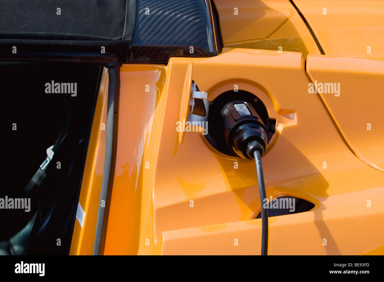 Electric car plugged into a socket, emission-free refueling, charging ...