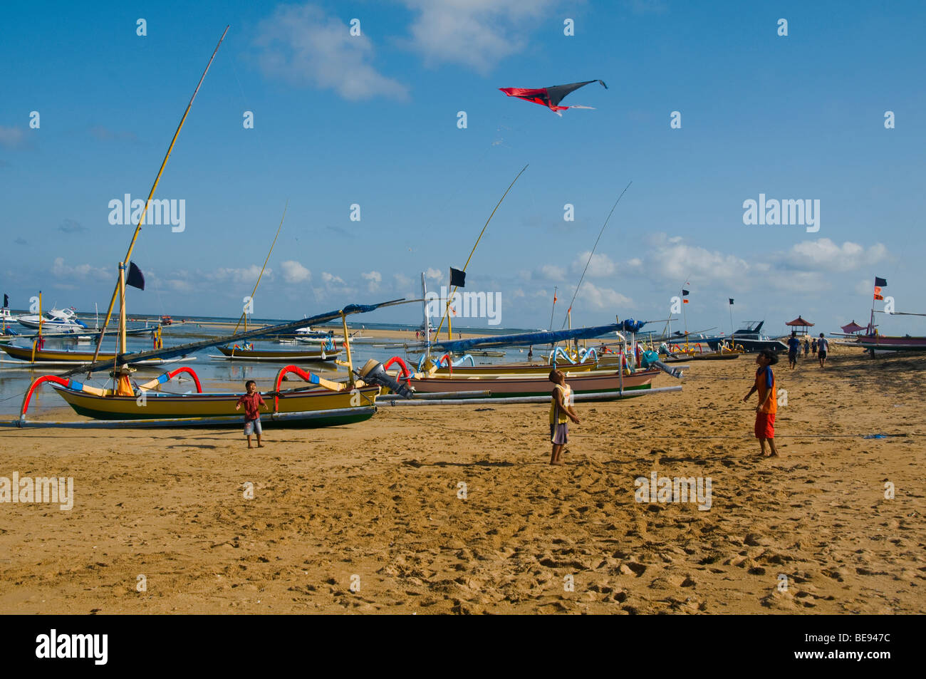 boys flying kites on the beach in Bali Indonesia Stock Photo - Alamy