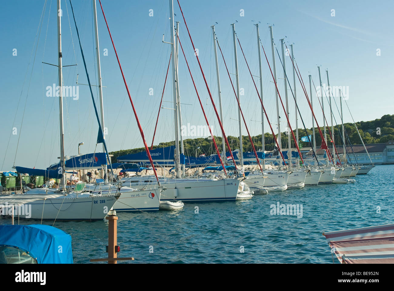 Sunsail flotilla of sailboats moored at quay hi-res stock photography ...