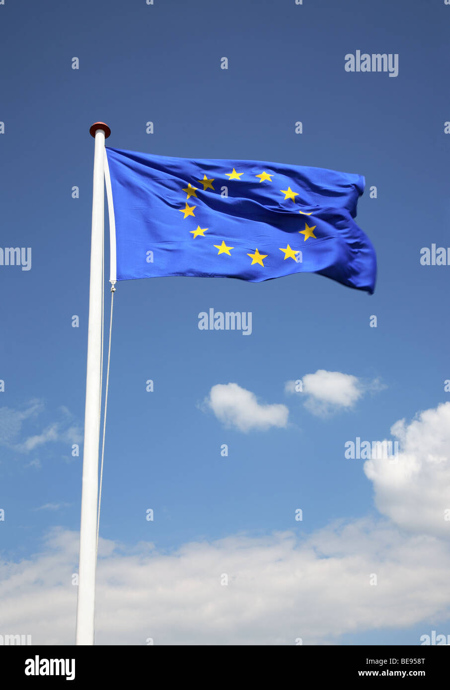 The European Union flag against a blue sky Stock Photo - Alamy