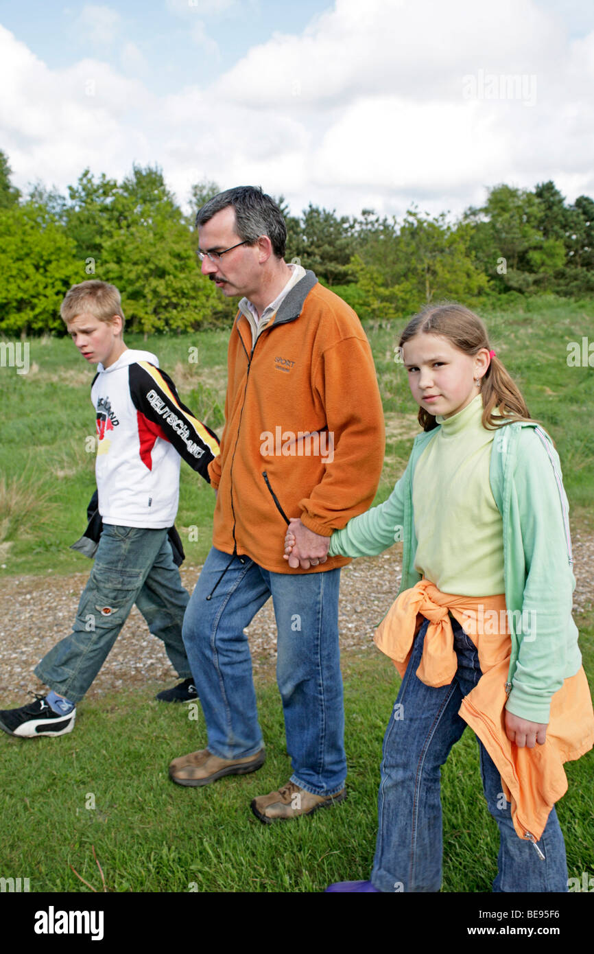 a father and his two children going for a walk in Jegum, Denmark Stock ...