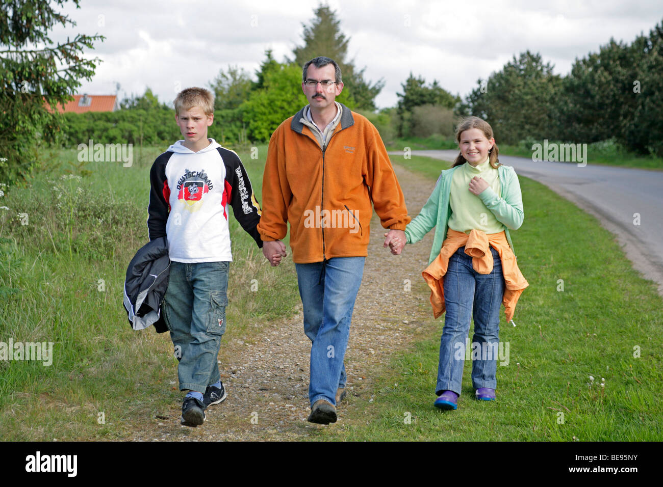 a father and his two children going for a walk in Jegum, Denmark Stock ...