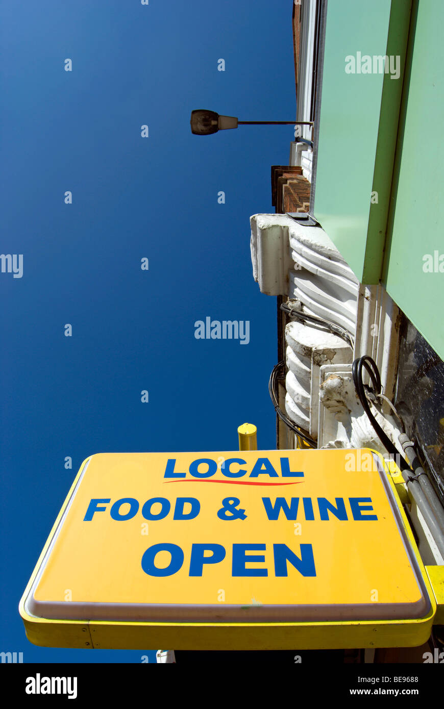yellow and blue shop sign for local food and wine, in twickenham ...