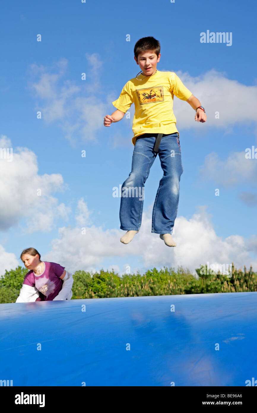 two kids jumping on a bouncy castle together, Denmark Stock Photo - Alamy