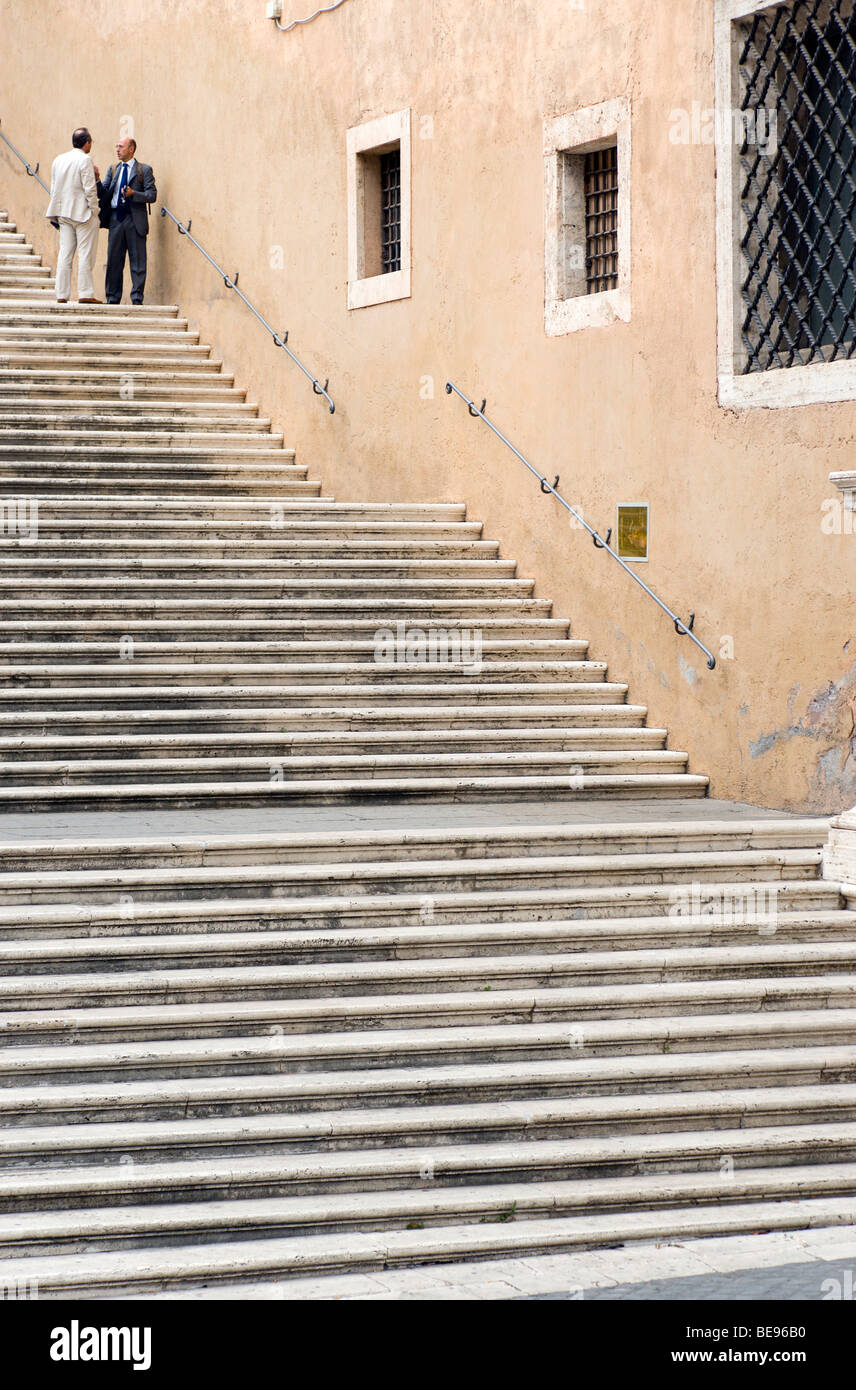 ITALY Rome Lazio Two men talking in conversation on steps beside the ...