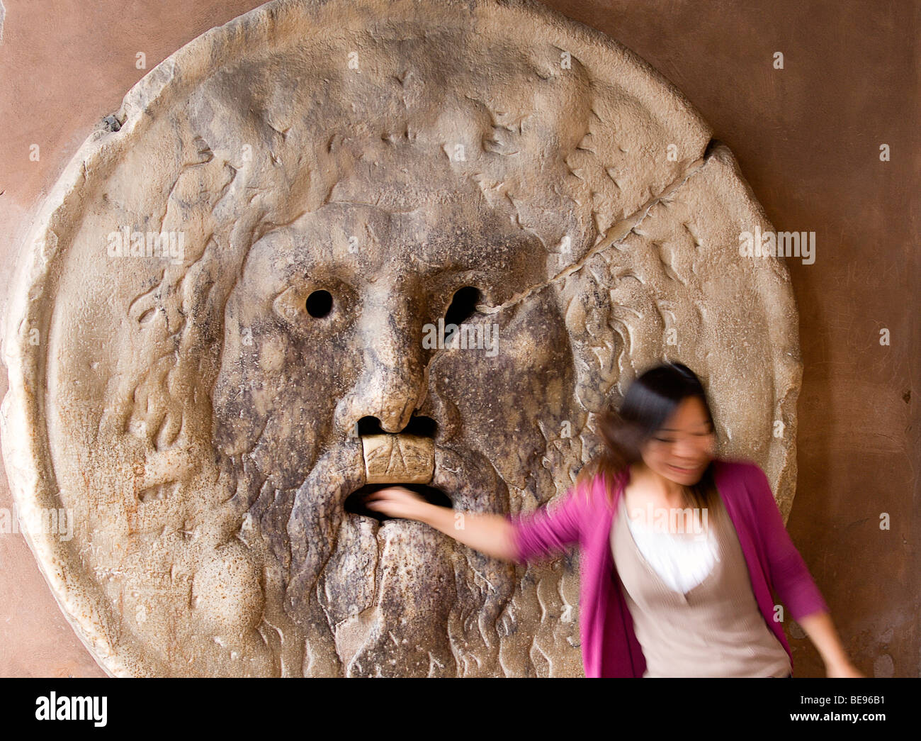 ITALY Rome Lazio Woman with her hand in the jaws of The Bocca della ...