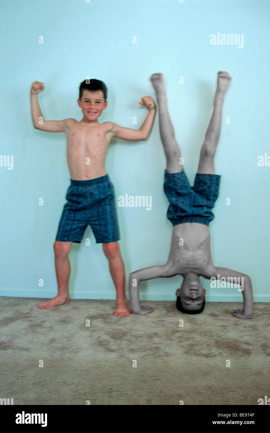 upright & upside down 11 year old twin boys posing against a wall Stock ...