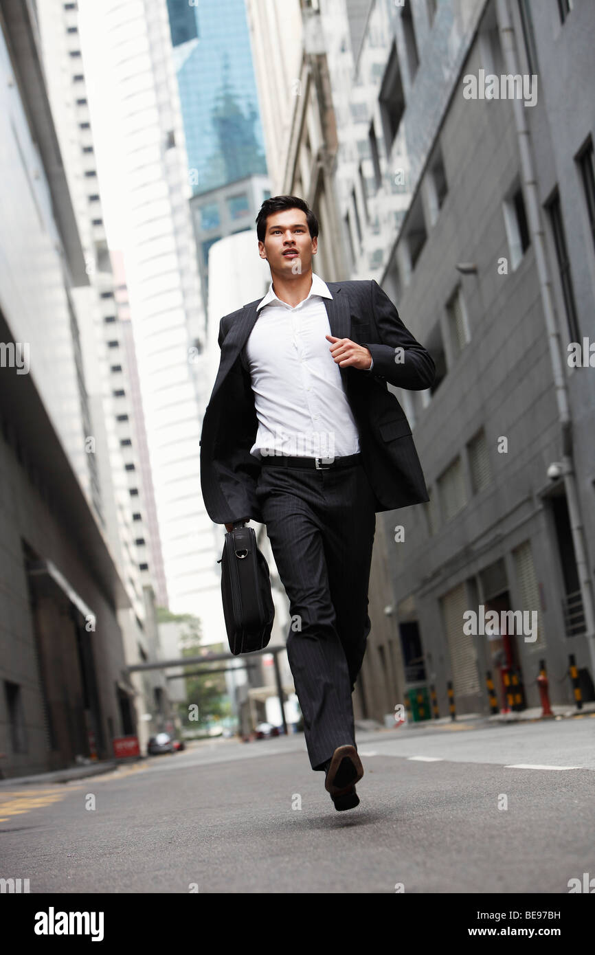 businessman running down street Stock Photo - Alamy
