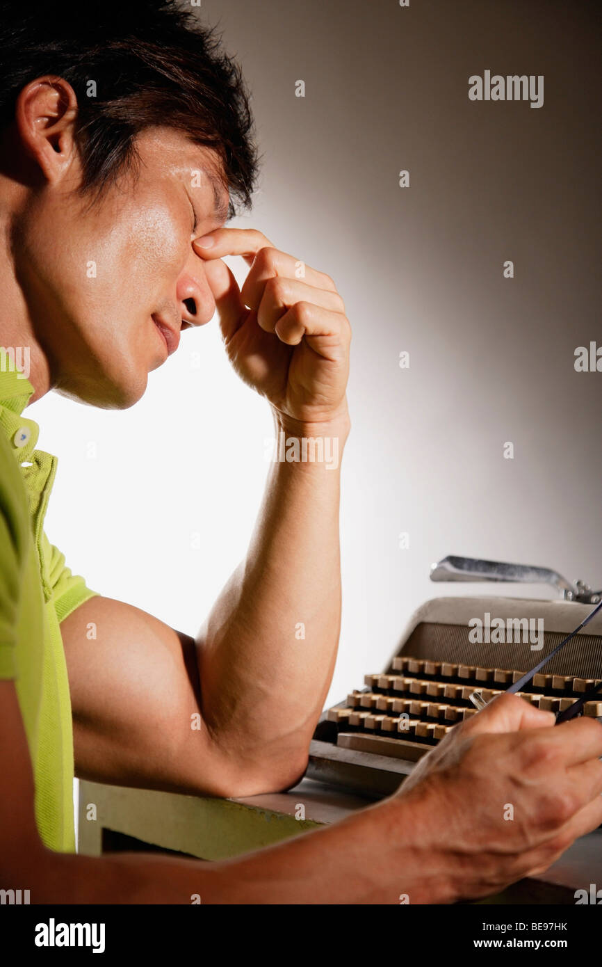 Profile of man at type writer Stock Photo - Alamy