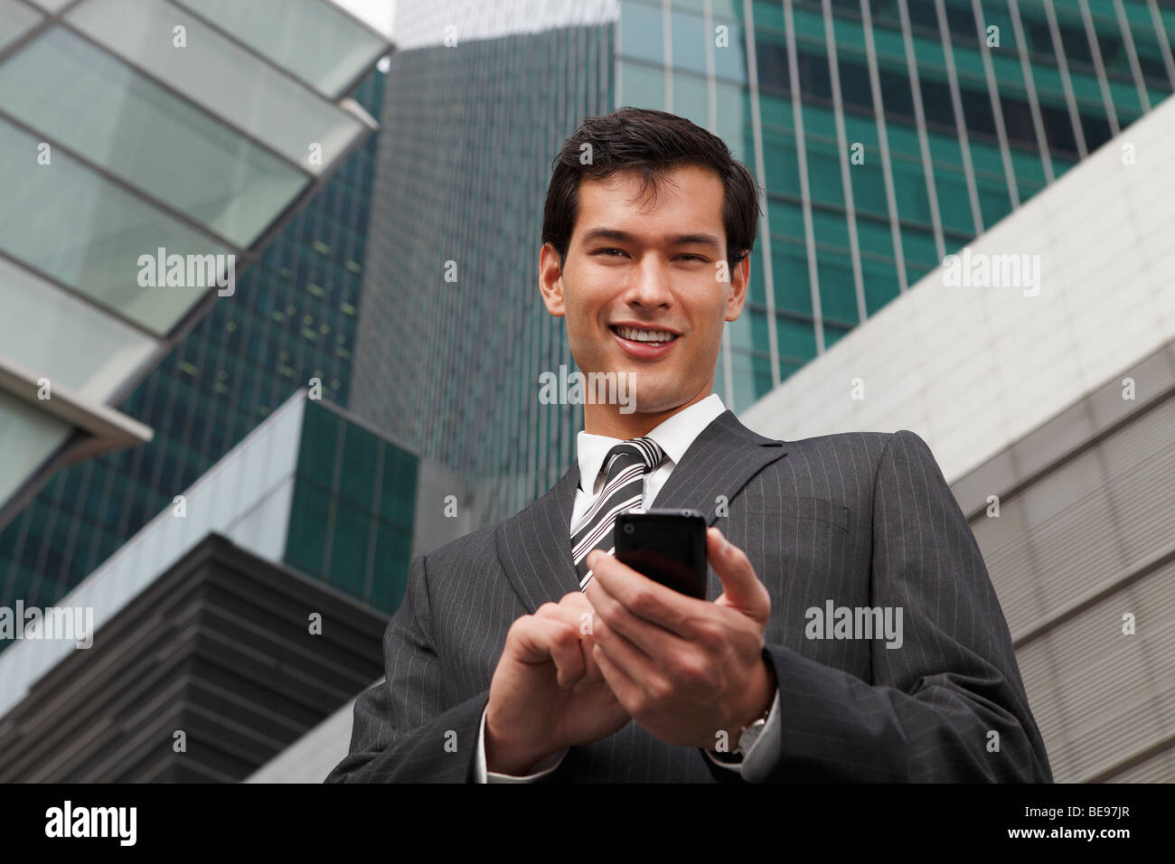 business man in a suit using mobile phone Stock Photo - Alamy