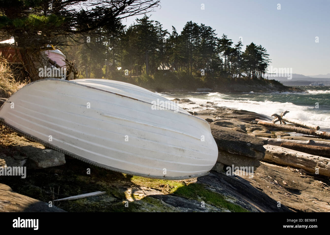 Overturned rowboat on rocky shoreline along Berry Point Road, Gabriola ...