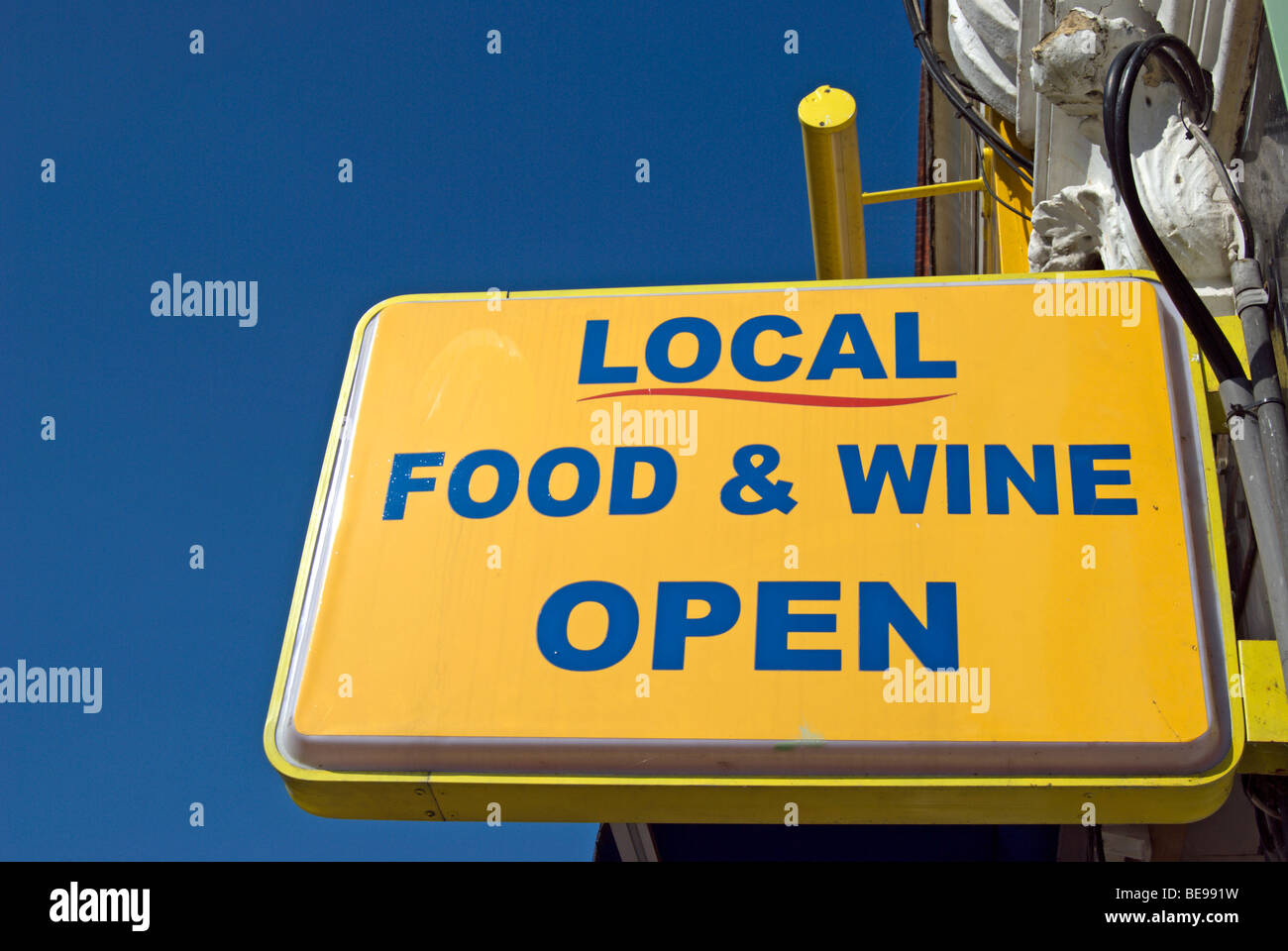 yellow and blue shop sign for local food and wine, in twickenham ...