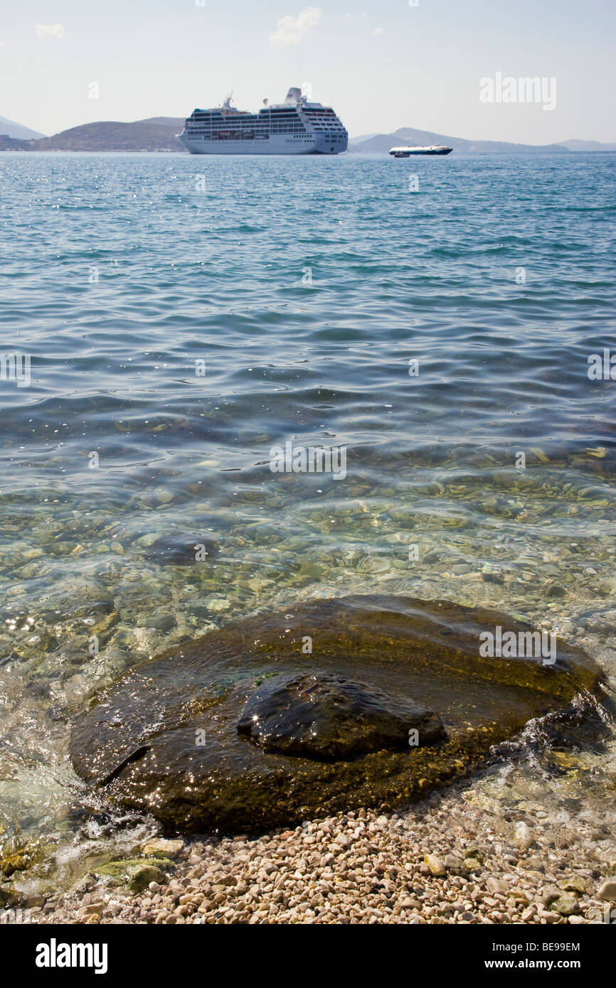 Waterfront with Rock in water and cruise ship in distances Stock Photo ...