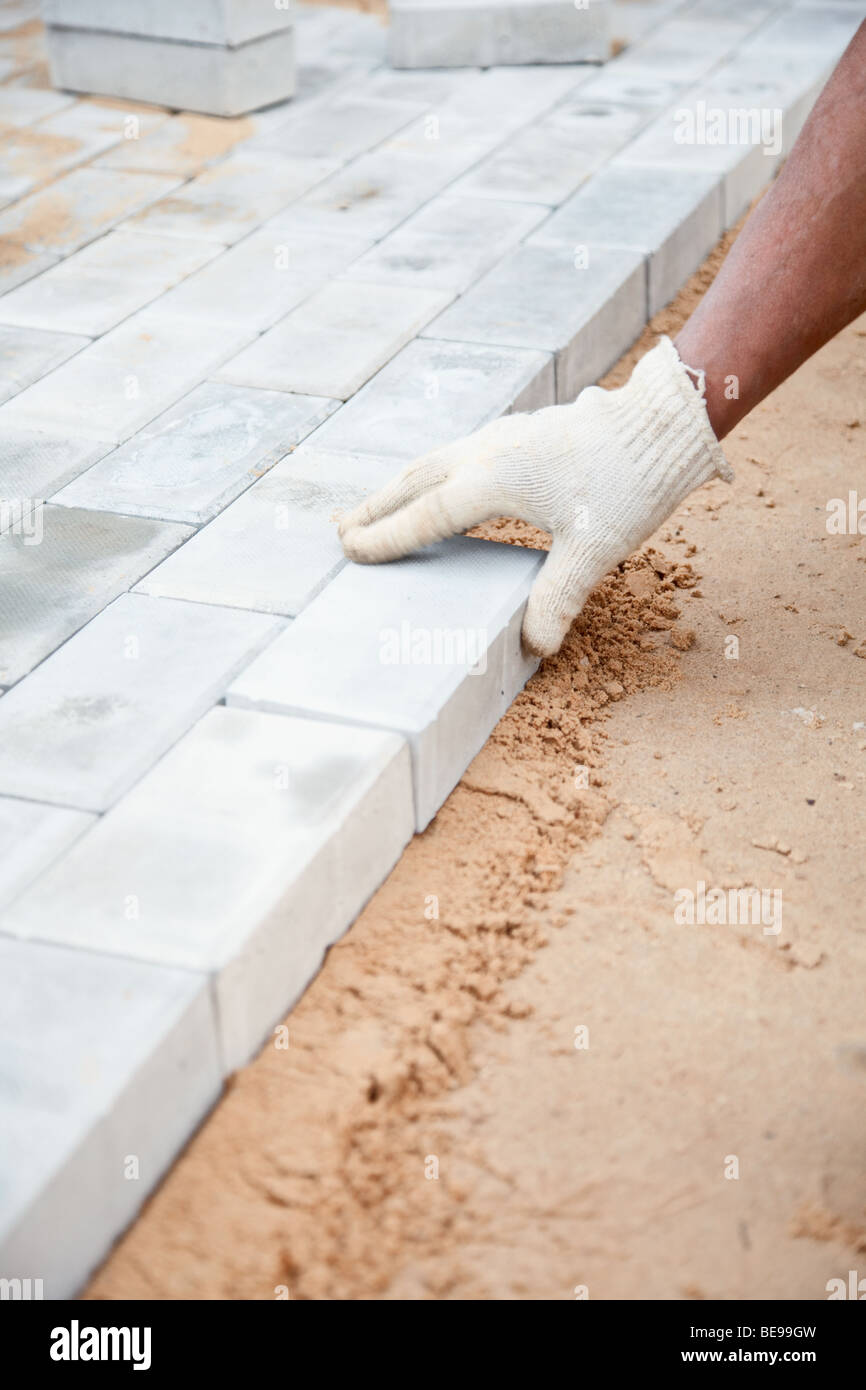 Installation of a brick platform - laying of bricks on sand Stock Photo ...