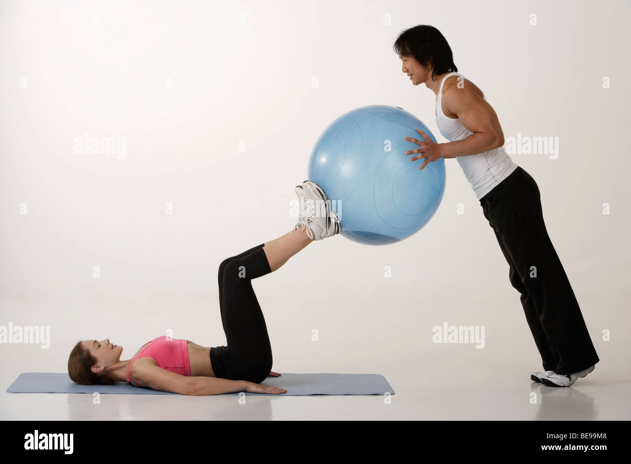 Couple working out with exercise ball Stock Photo - Alamy