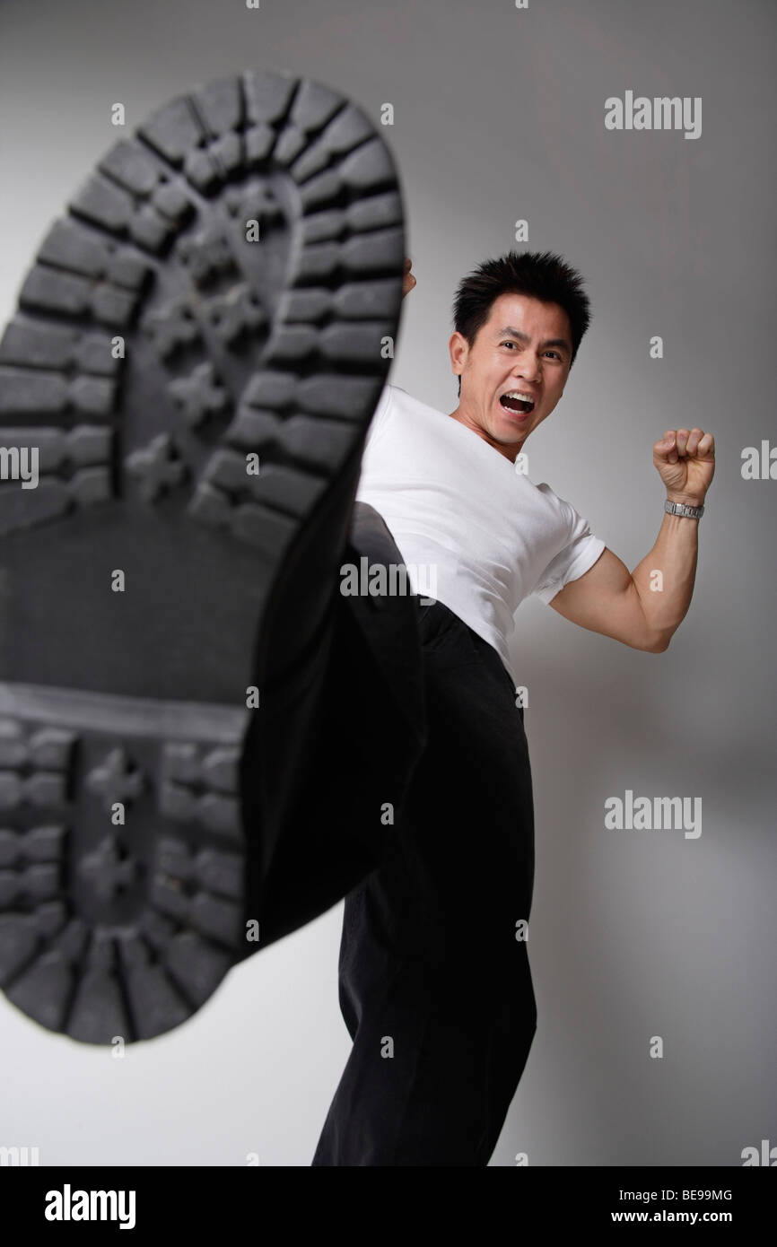 man kicking at camera Stock Photo - Alamy