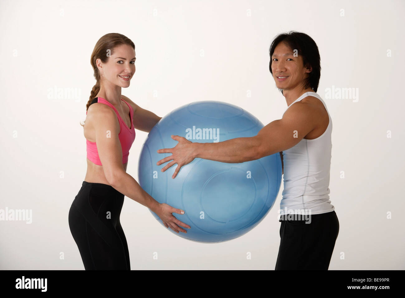 Couple working out with exercise ball Stock Photo - Alamy