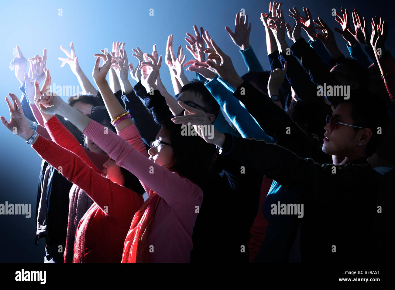 crowd cheering with hands raised Stock Photo - Alamy