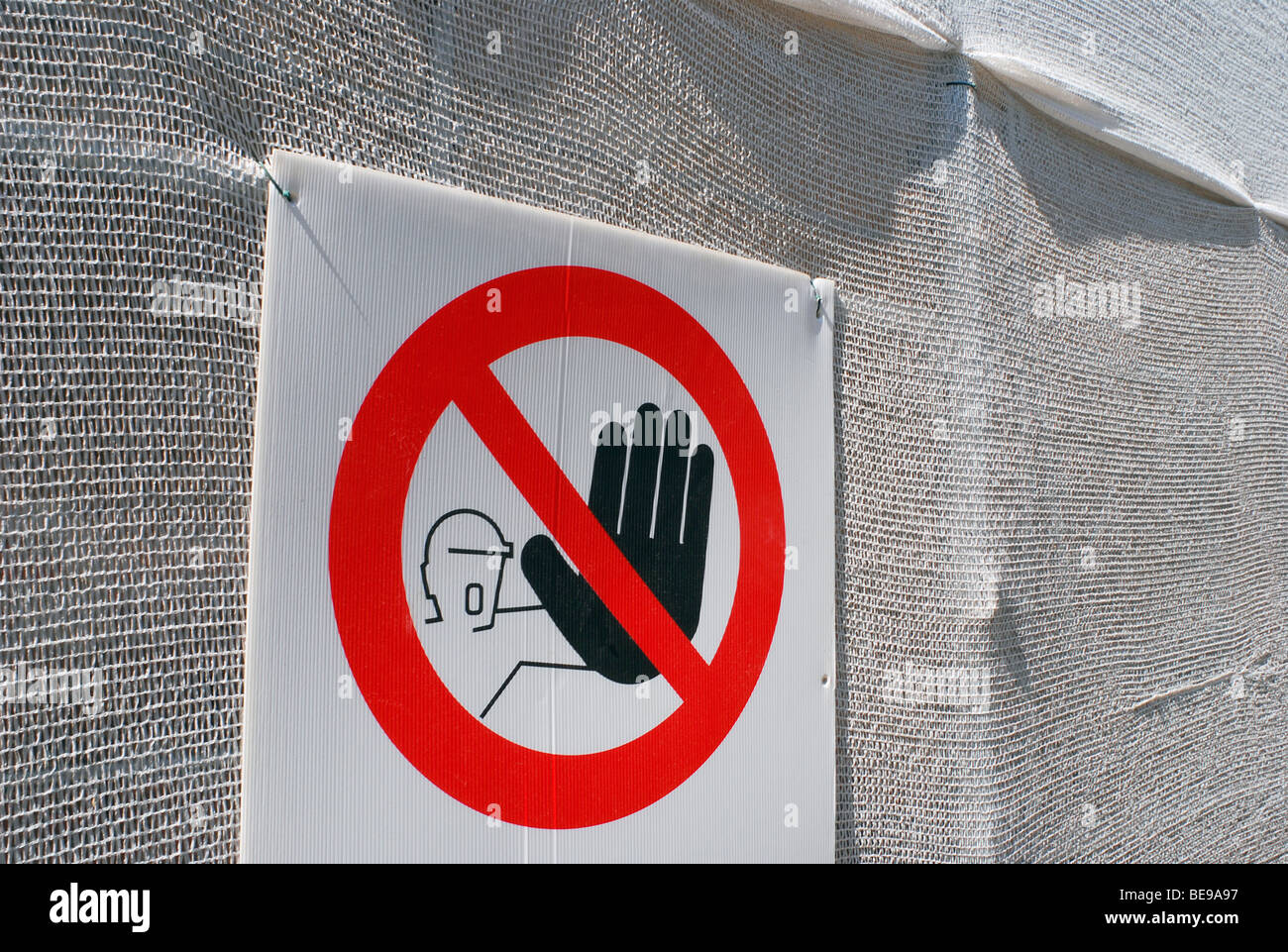 keep out warning sign on building draped in netting Stock Photo - Alamy