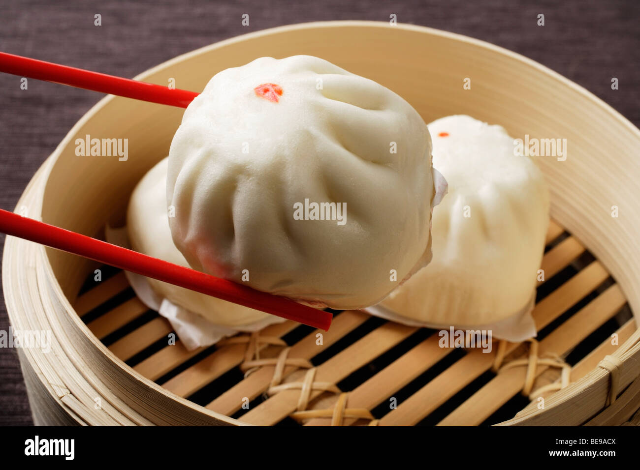 red chopstick holding dim sum (bao Stock Photo - Alamy
