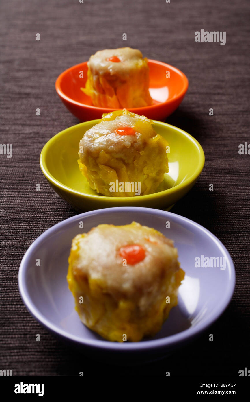 dim sum on colored plates Stock Photo - Alamy